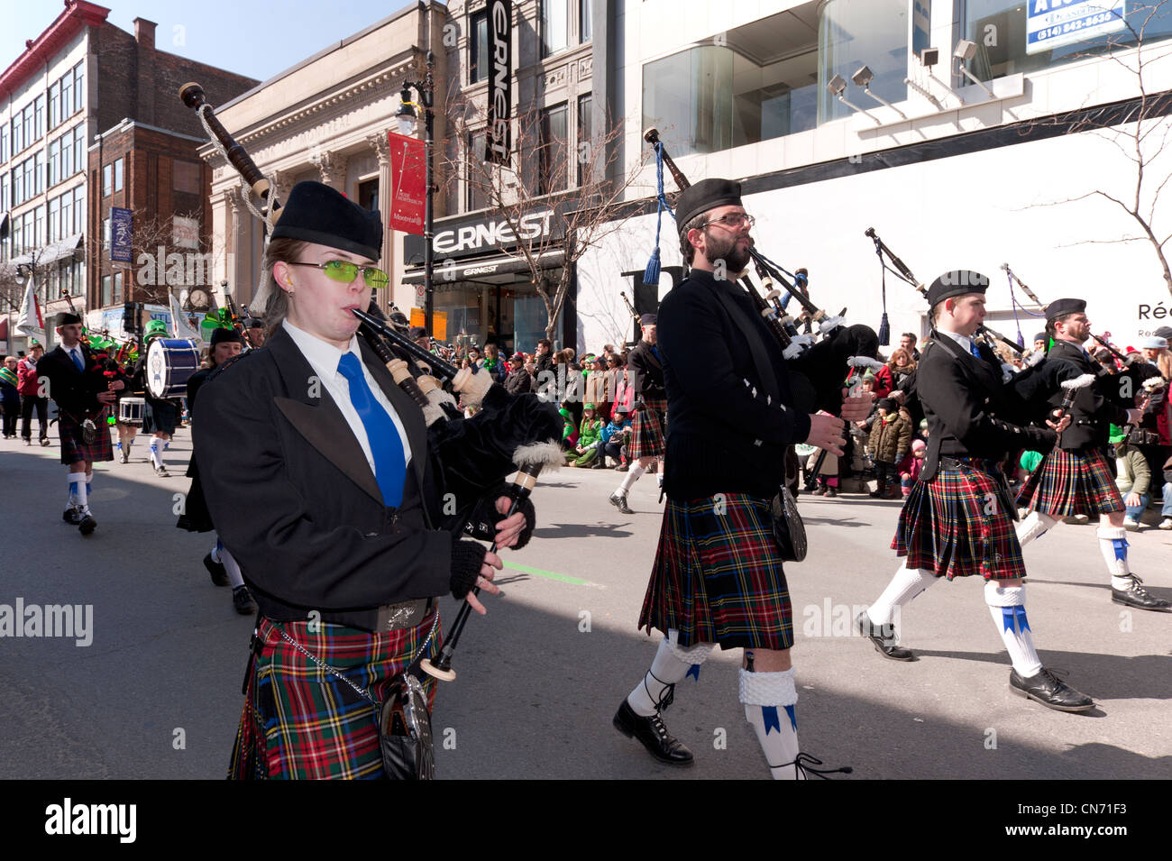 Traditional pipe band marching on Ste Catherine street in Montreal ...