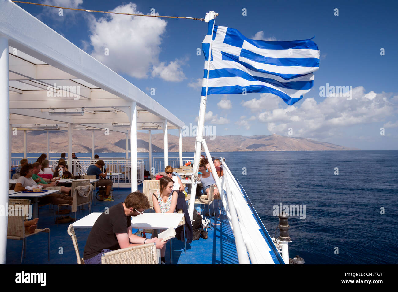 Travelers on the deck of a Greek ferry sailing on the Aegean Sea Stock ...