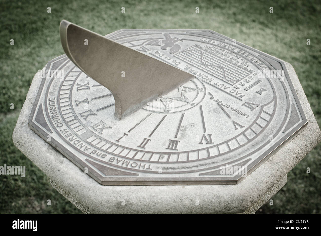 old sculpture in garden to tell the time of day with the angle of the ...