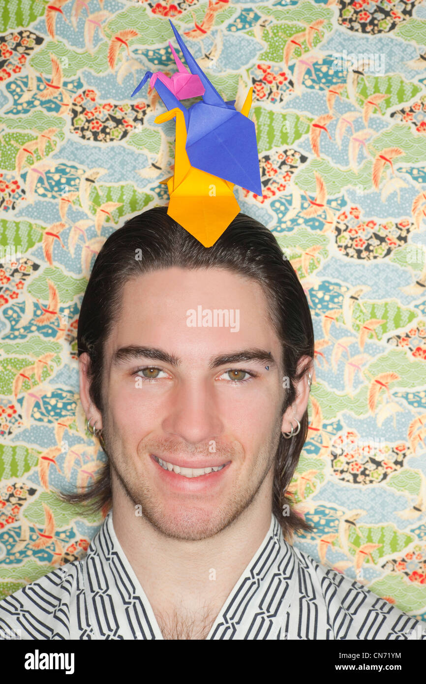 Portrait of young caucasian man wearing Japanese clothes balancing ...