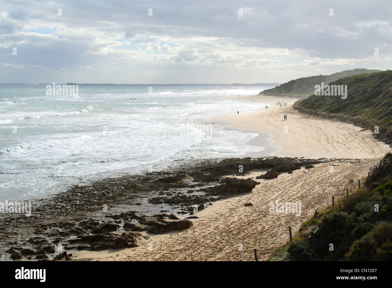 view of a long stretch of beach on the coast Stock Photo - Alamy