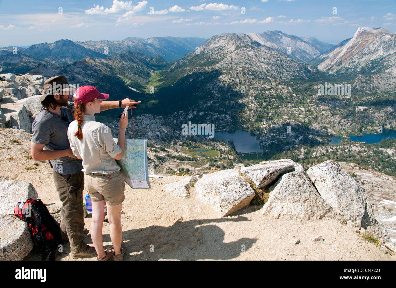 Hiker pointing out the sights from the summit of Eagle Cap in Oregon's ...