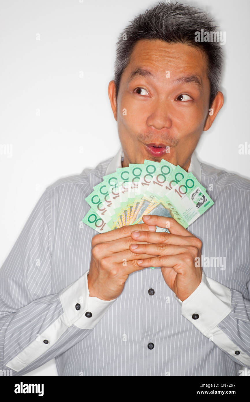 Portrait of chinese asian man holding money and laughing Stock Photo ...