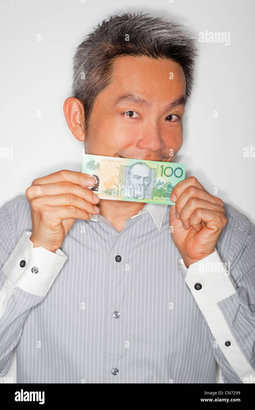 Portrait of chinese asian man holding money and smiling Stock Photo - Alamy