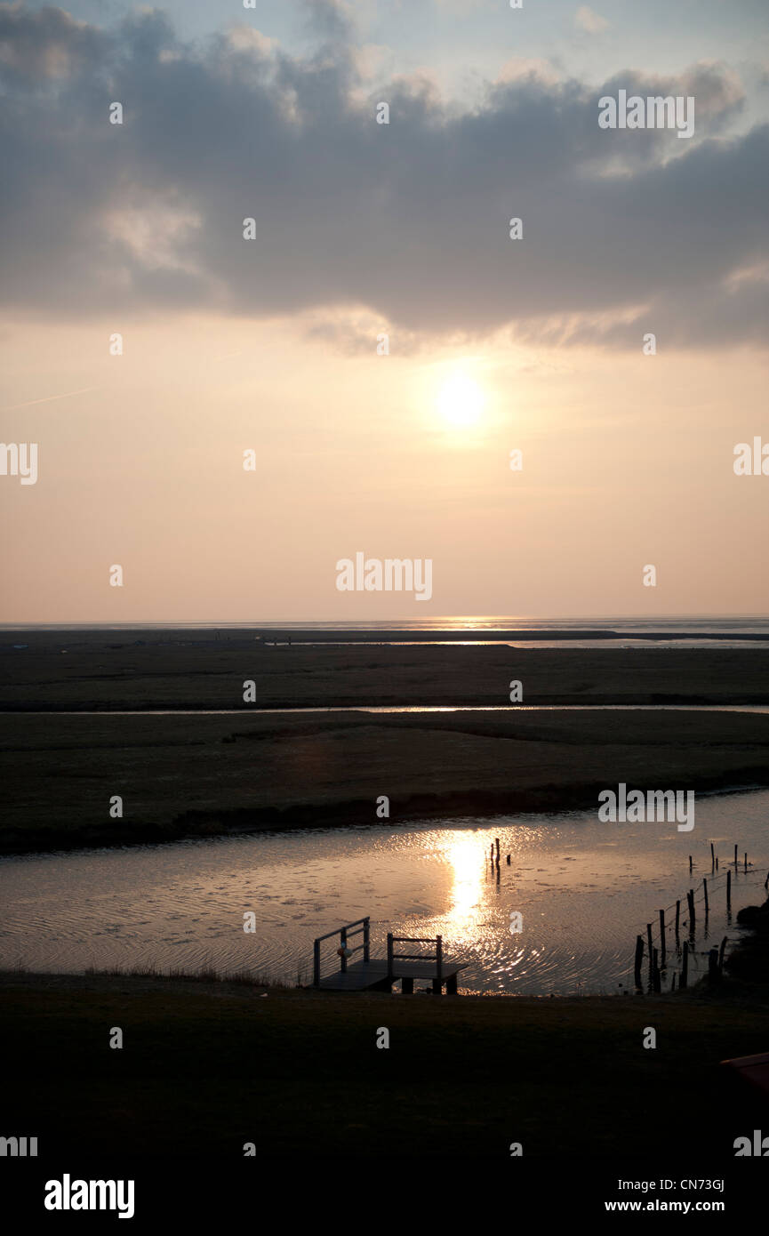 Sun setting over the North Sea island Hallig Langeness in the UNESCO ...
