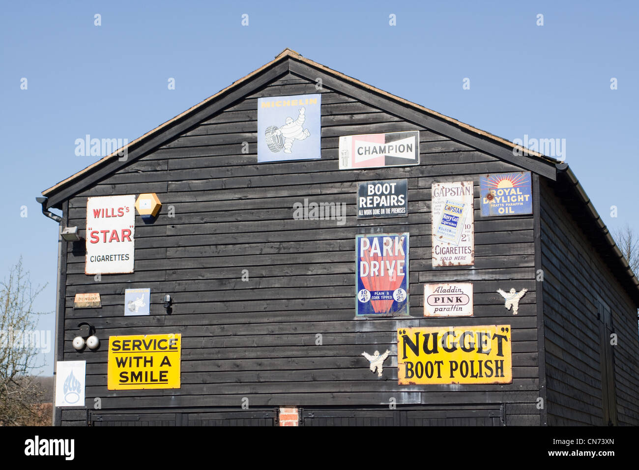 A barn with old signs on it in Buckland Common, Buckinghamshire Stock ...