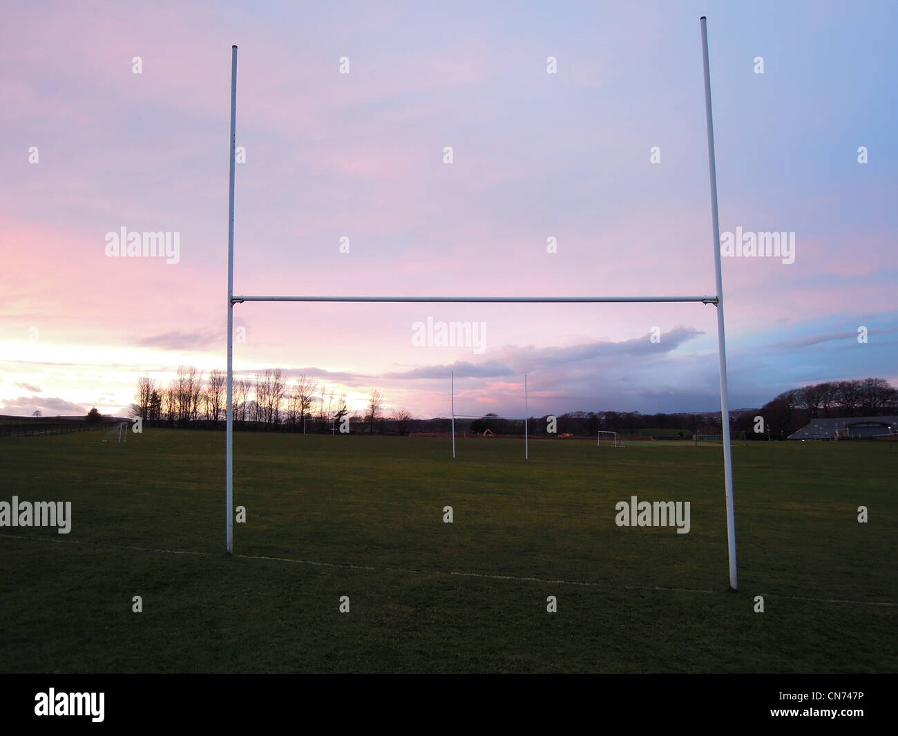Rugby goal posts on a school sports field beneath twilight sky ...