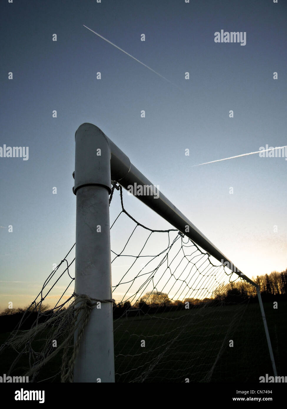 Football goal posts on a school sports field beneath twilight sky ...
