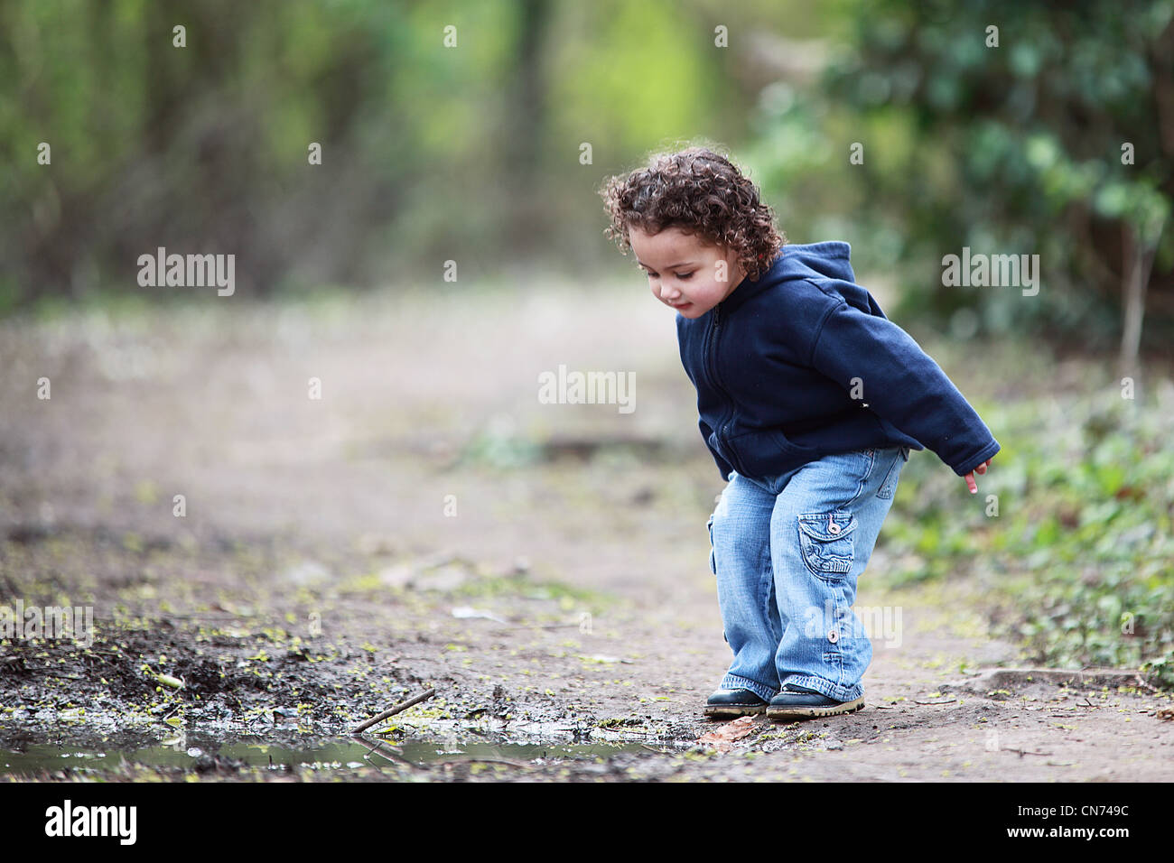 Child Jumping in Puddle Stock Photo - Alamy