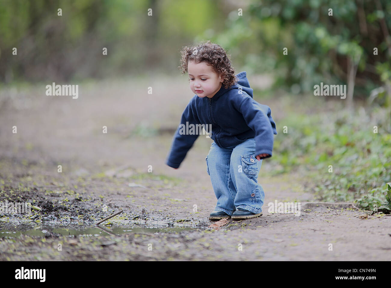 Child Jumping in Puddle Stock Photo - Alamy