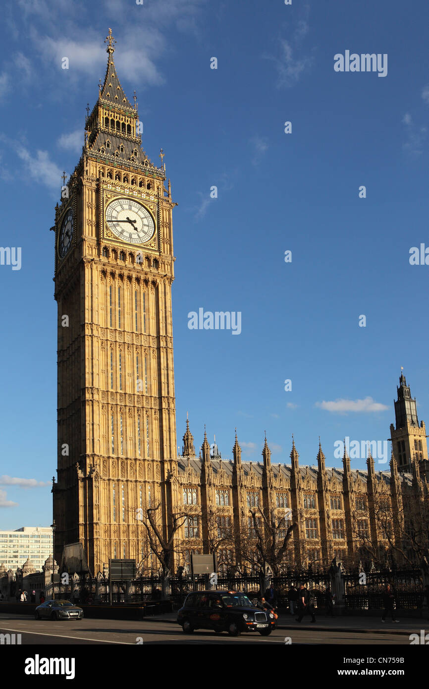 A black Hackney Cab runs past the Palace of Westminster in Westminster ...
