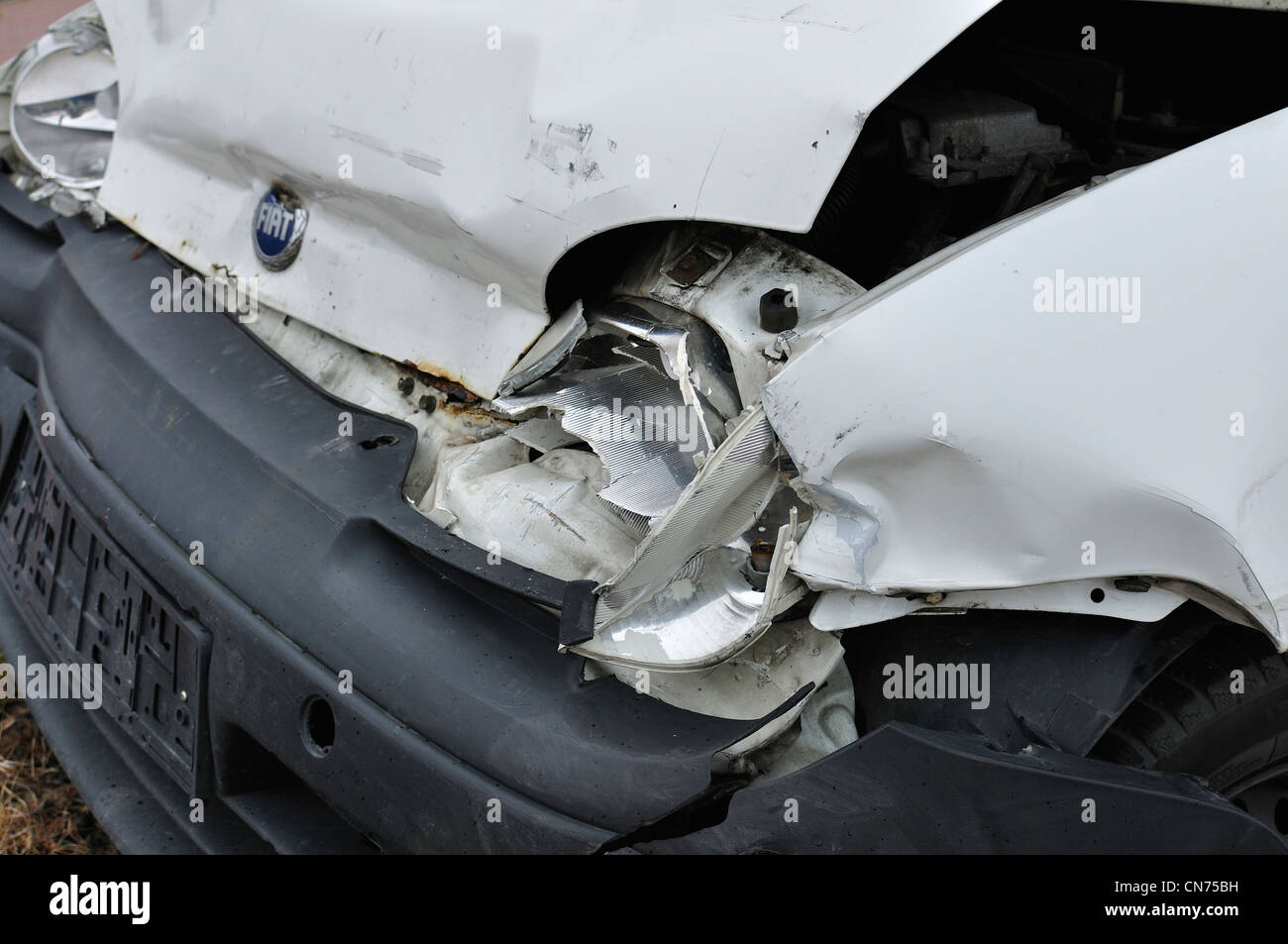 Damaged car in an accident, small city car smashed in city traffic ...