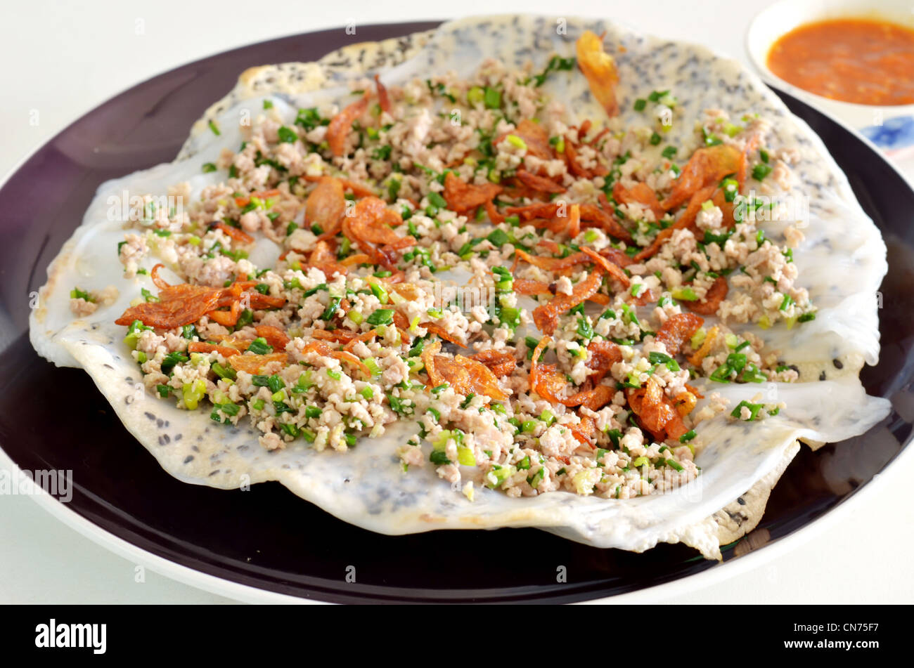 Vietnamese rice noodle with pork sliced , vegetable and fried onion ...