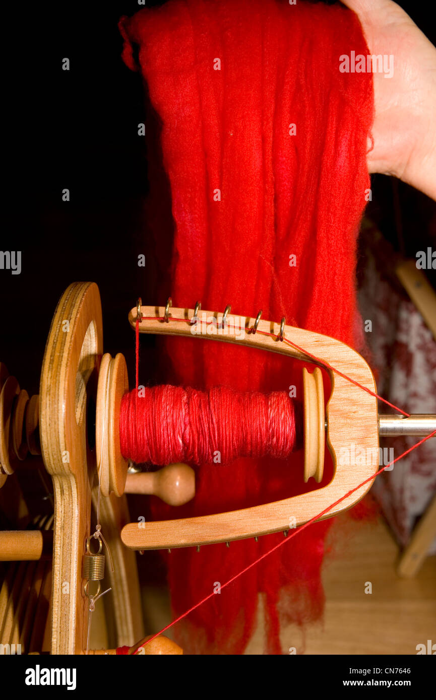 spinning red wool home dyed Stock Photo - Alamy
