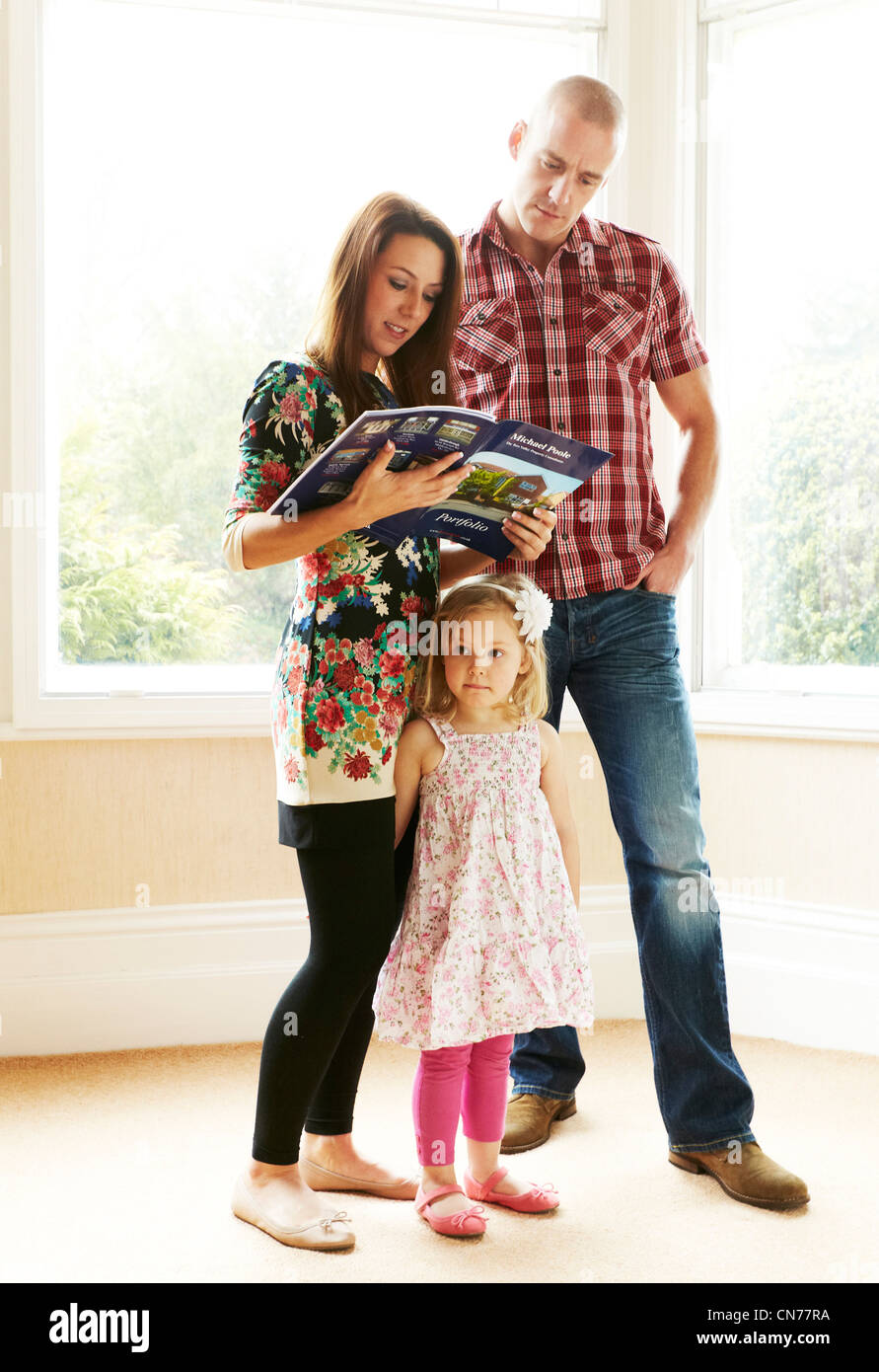Young family viewing property Stock Photo - Alamy