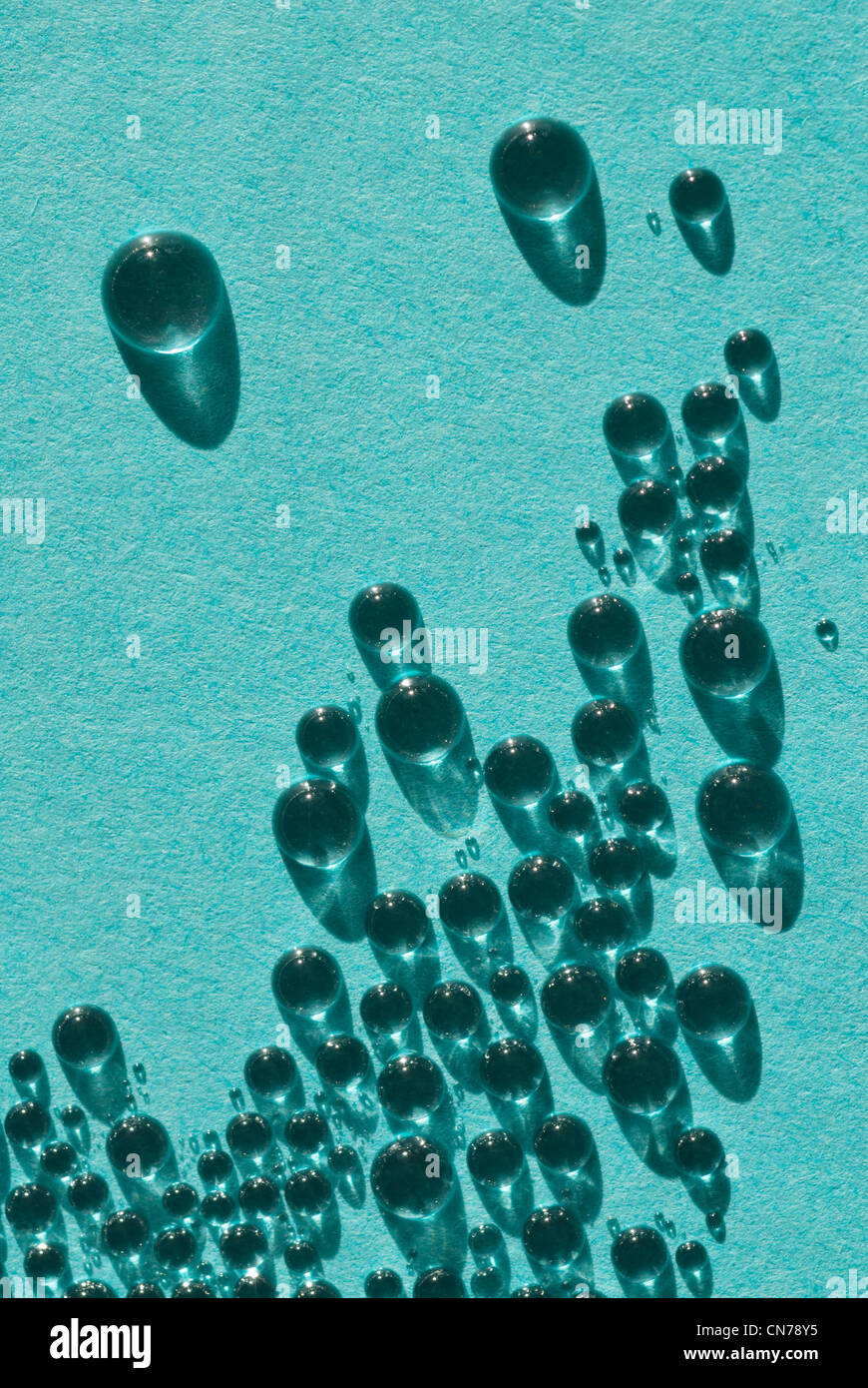 water droplets with light shining through, showing caustics Stock Photo ...