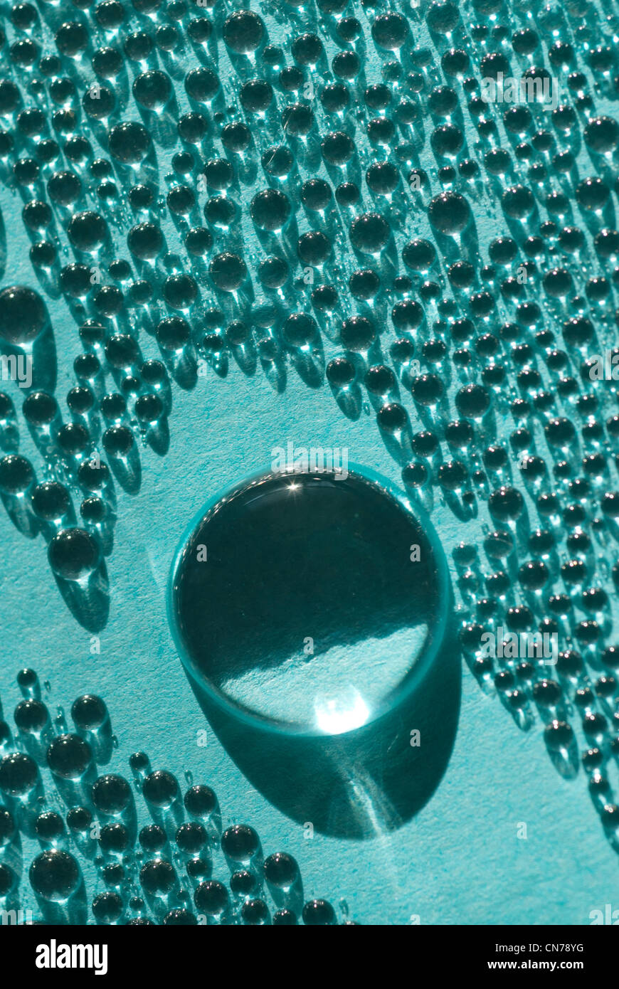 water droplets with light shining through, showing caustics Stock Photo ...