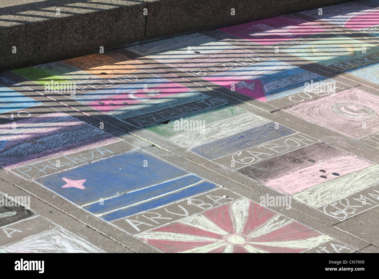 Chalk pavement drawing of flags of Cuba, Gabon, Aruba, Tunisia, at the ...