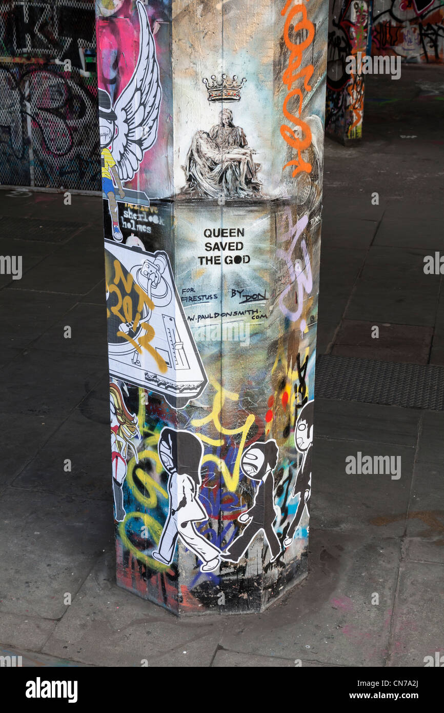 South Bank graffiti with text 'Queen saved God' on a stone column Stock ...
