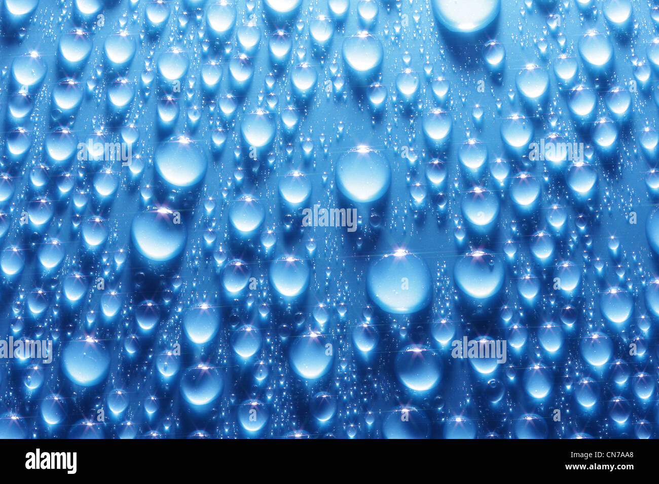 Shiny water drops on metallic blue surface Stock Photo - Alamy