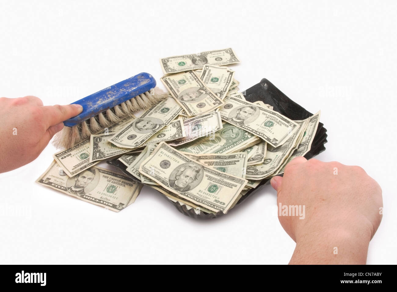 Sweeping up American Money Stock Photo - Alamy