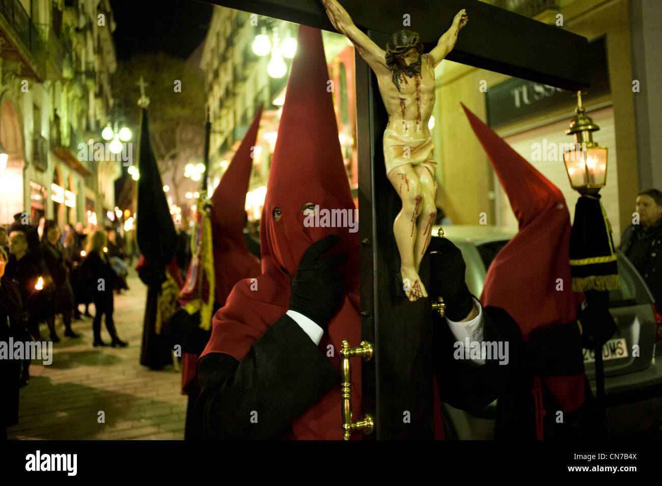 Nazarene carrying a cross with the crucified Christ during Holy Week ...