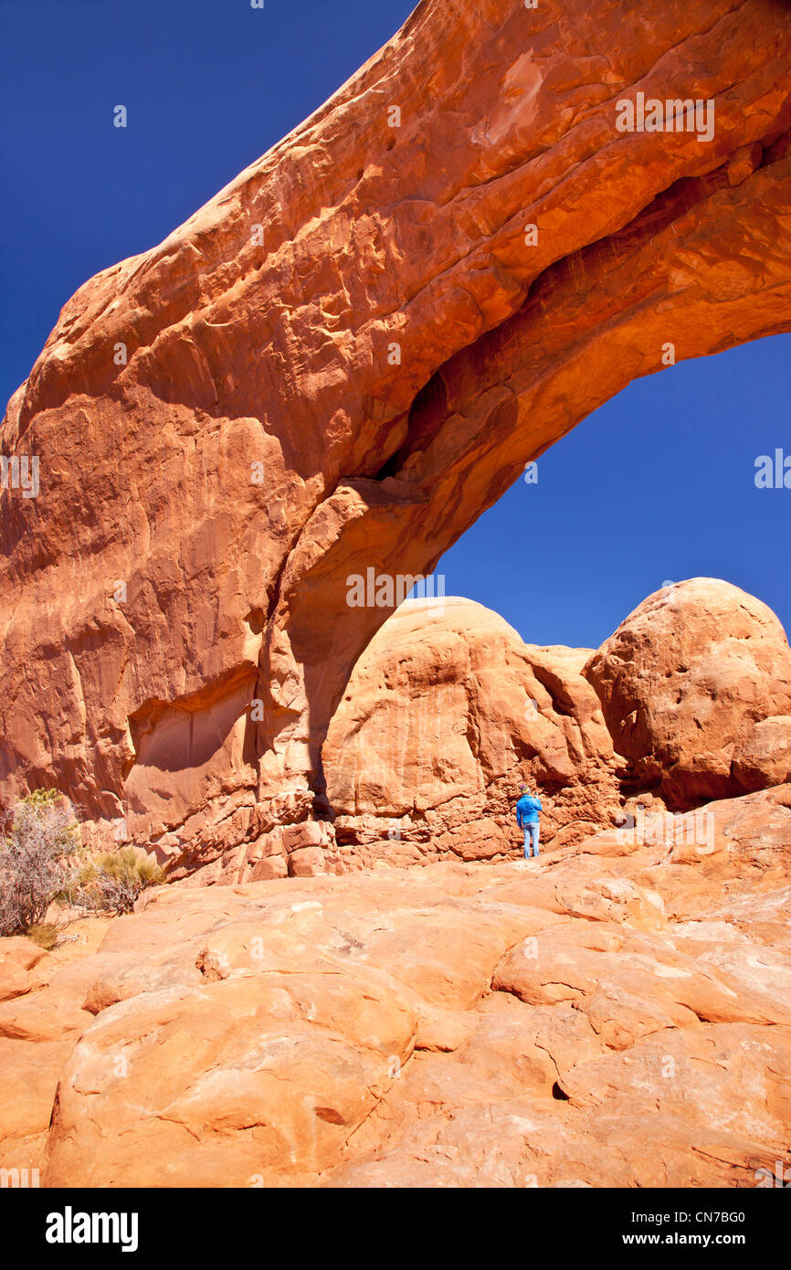 Lone tourist below the massive North Window Arch, Arches National Park ...