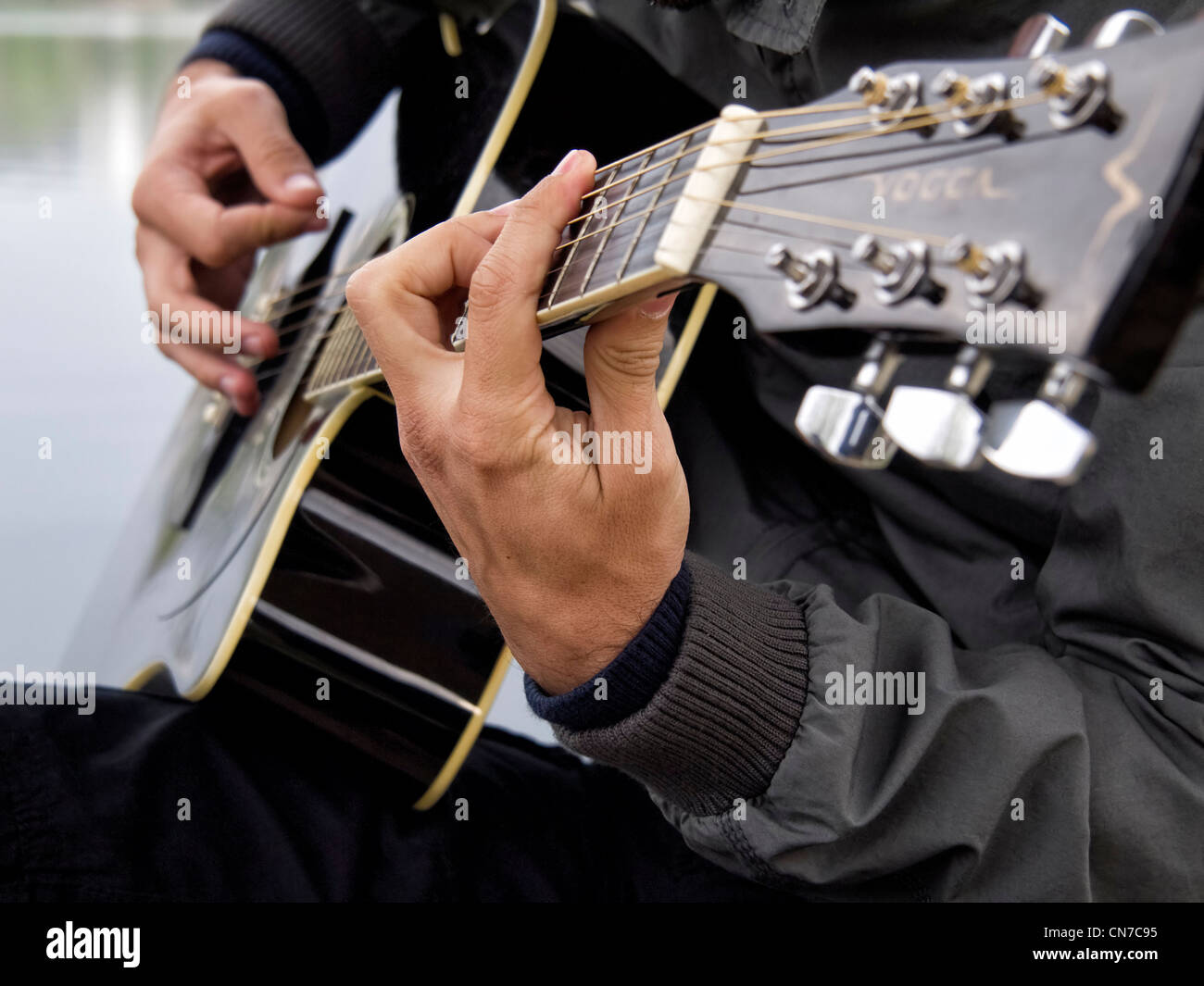 Close up of a man playing acoustic guitar Stock Photo - Alamy