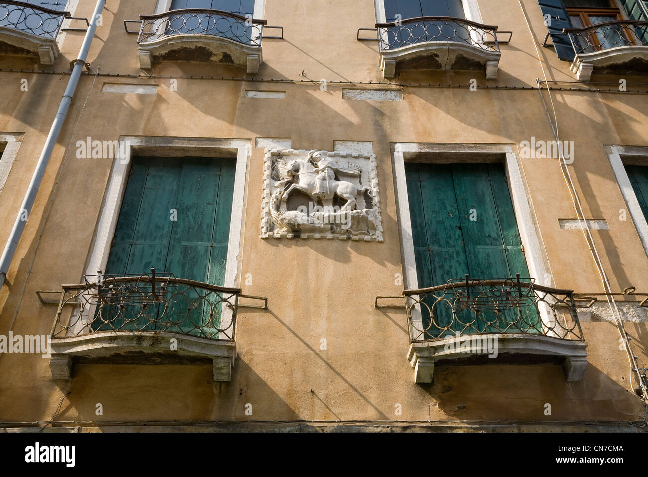Saint George and the dragon wall sculpture, elegant windows with ...