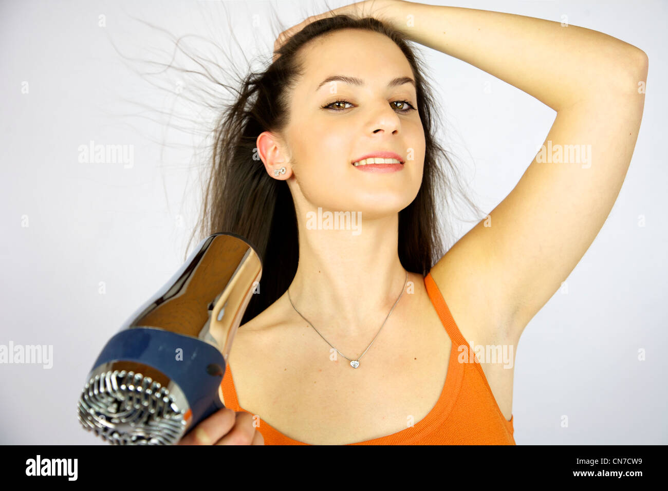 Pretty brunette female model drying her long hair Stock Photo - Alamy