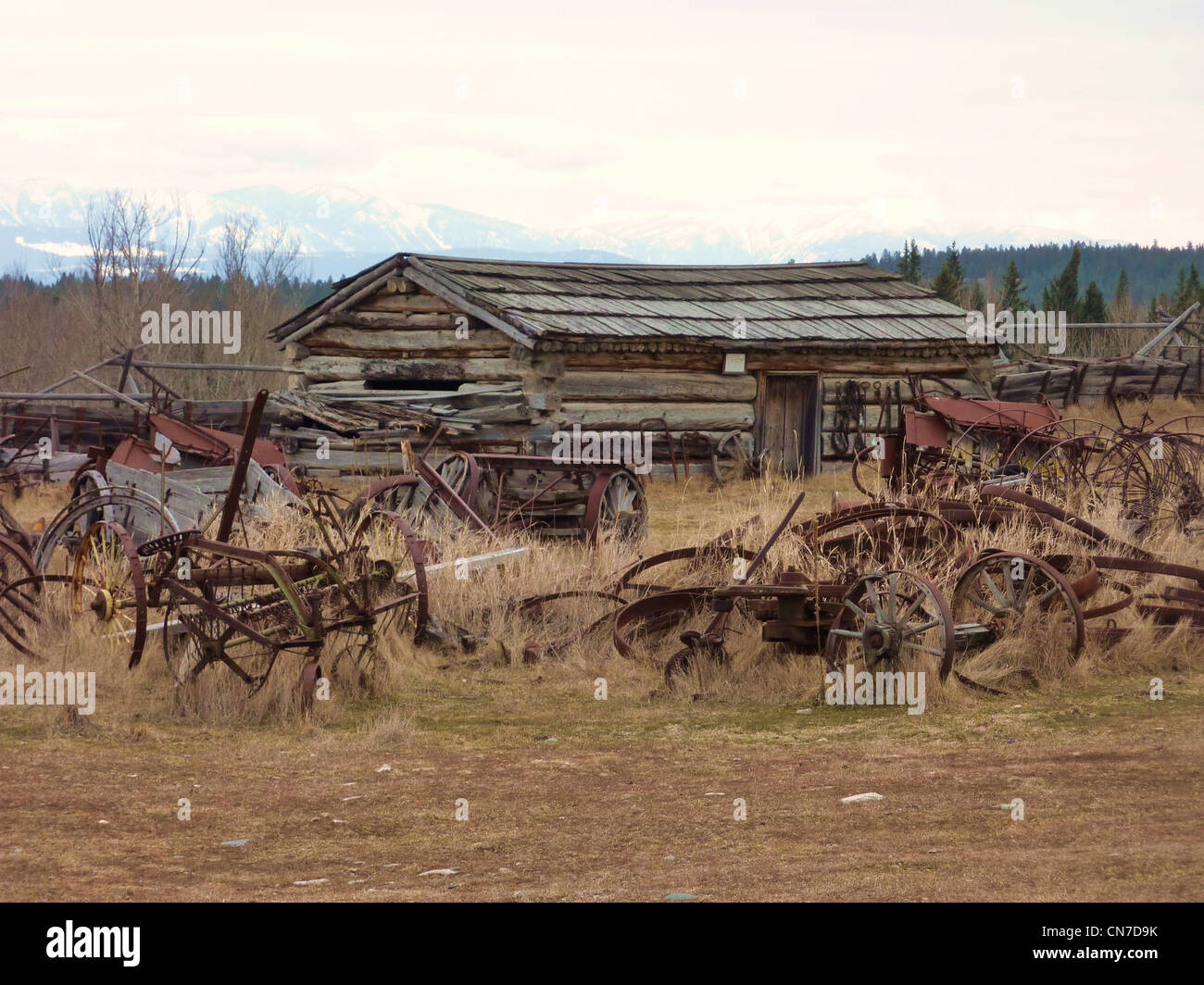 old barn and rusty antique farm equipment Stock Photo - Alamy