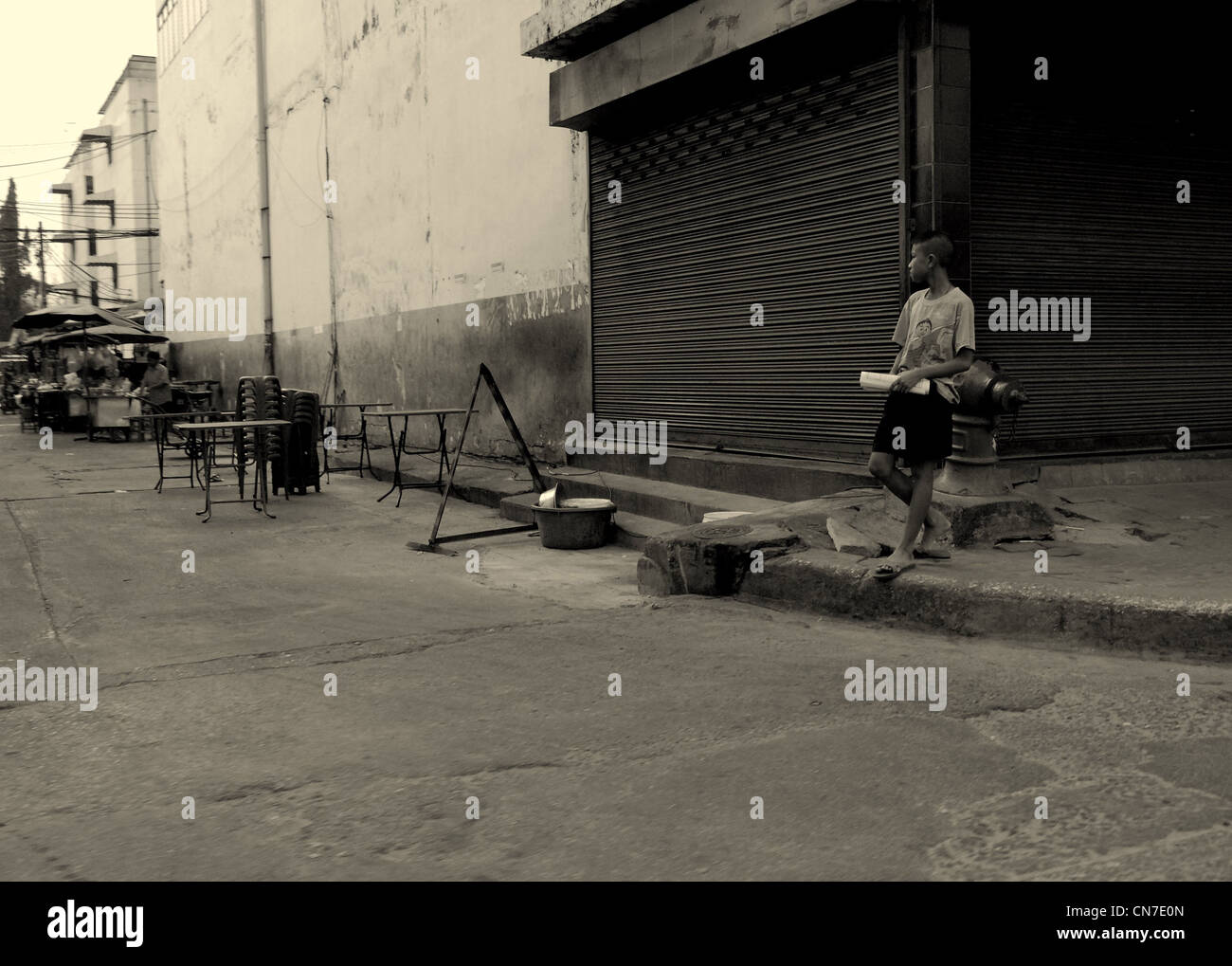 young boy standing on street corner, bangkok street life, bangkok ...