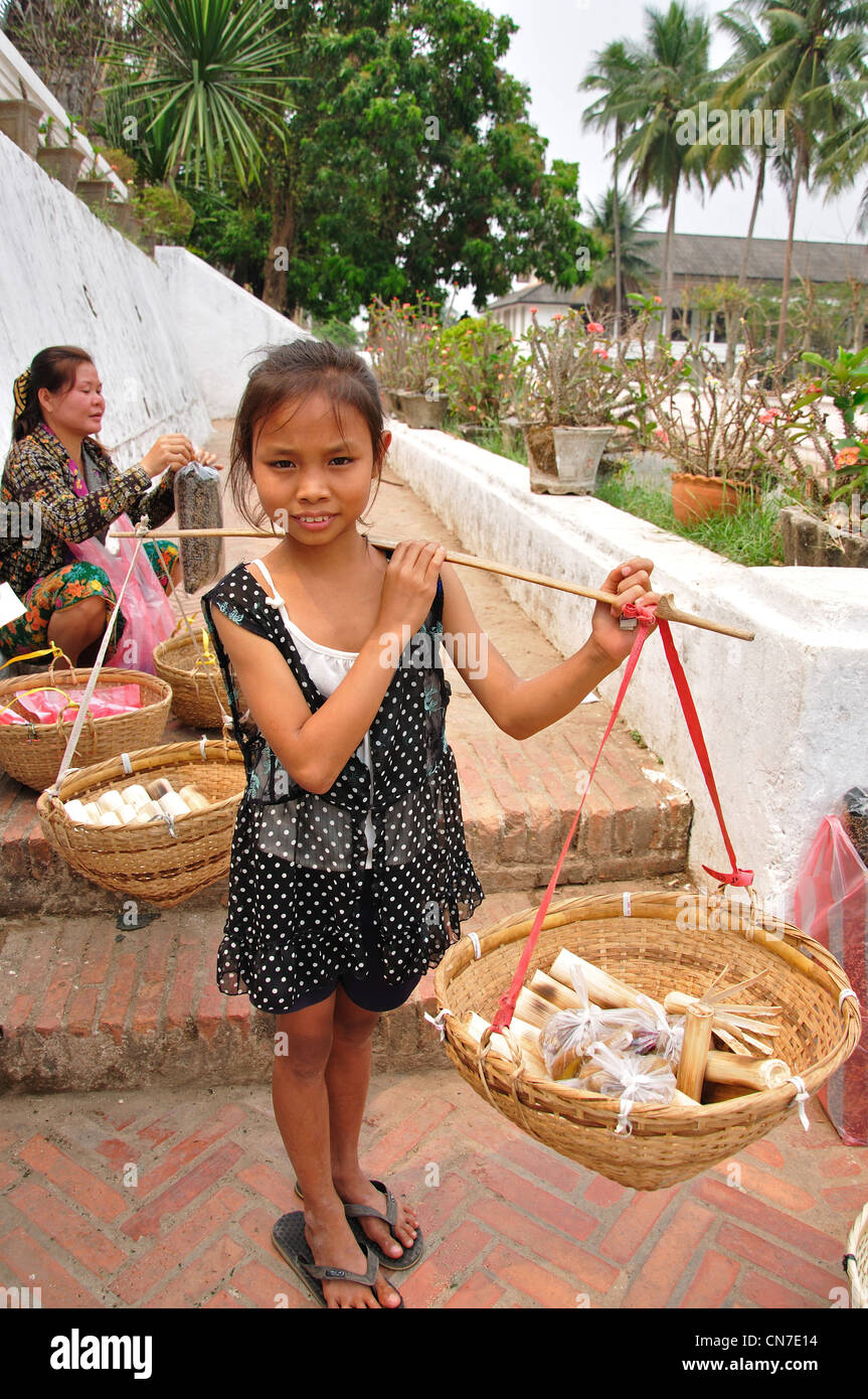 Young girl with bamboo carrying pole by steps to Mount Phou Si, Luang ...