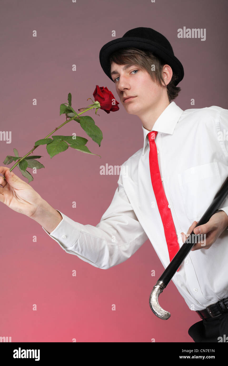 Young men with the red rose on colour background. Love and reflection ...