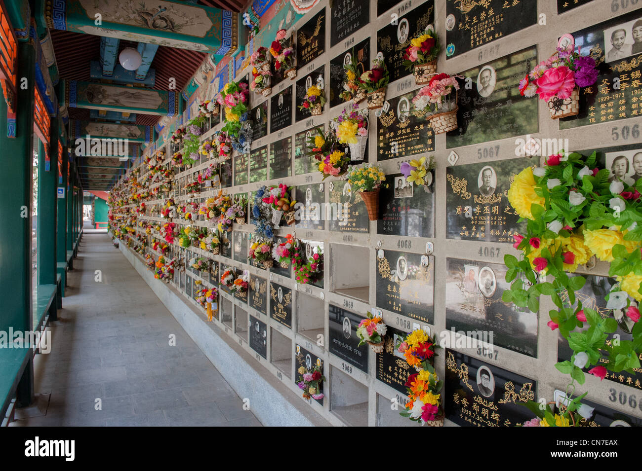 Beijing, Wanan cemetery. Cemetery wall with many flowers during the ...