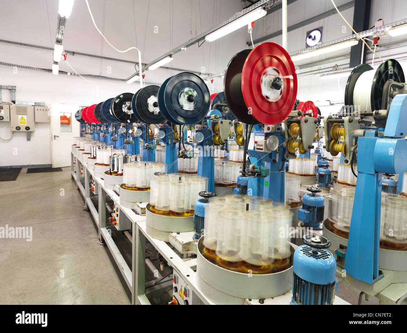 detail of an indoor industrial production line, in a thread factory ...