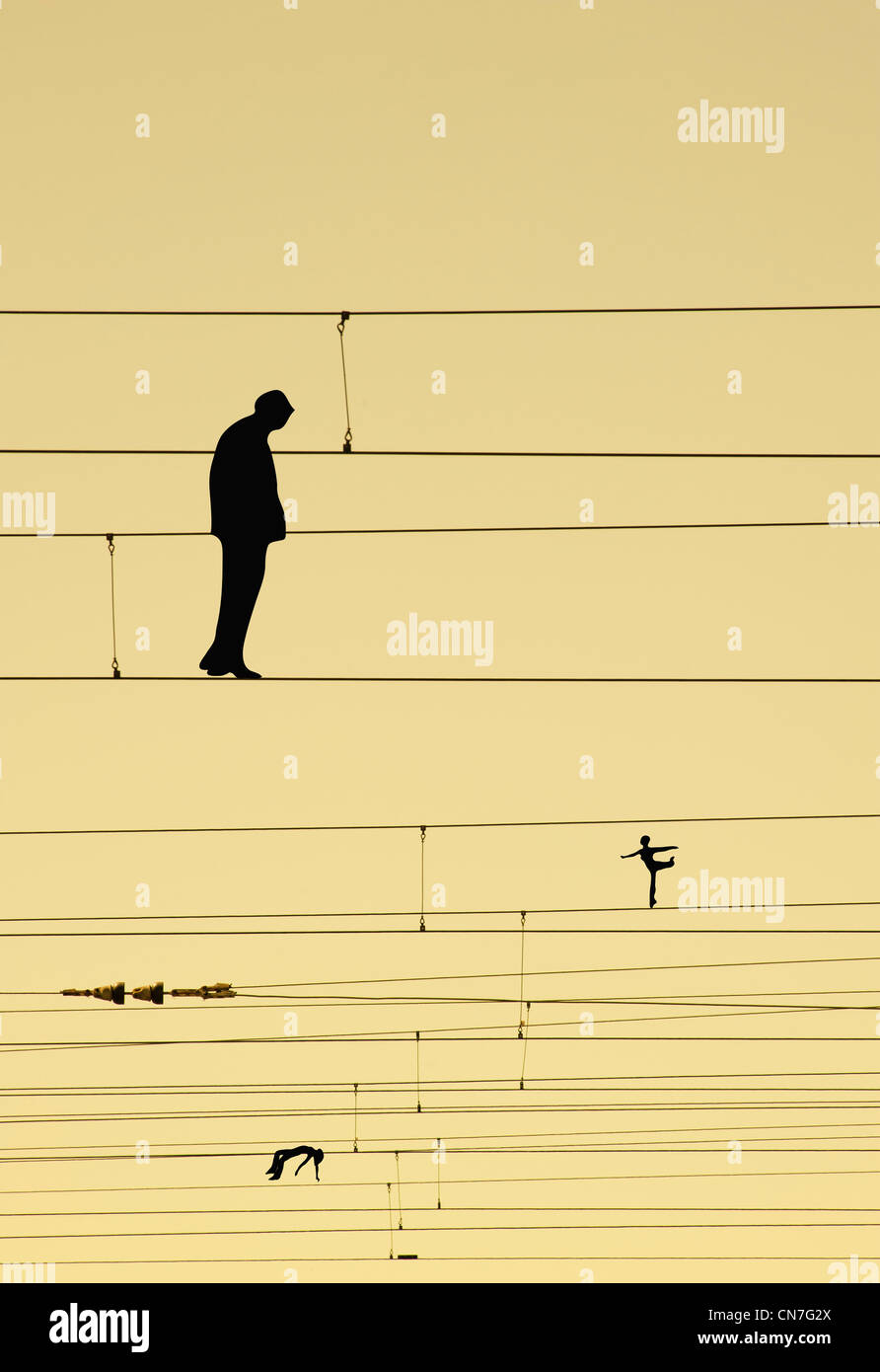 Man walking, balancing on wires. Woman balancing on wires on one leg ...
