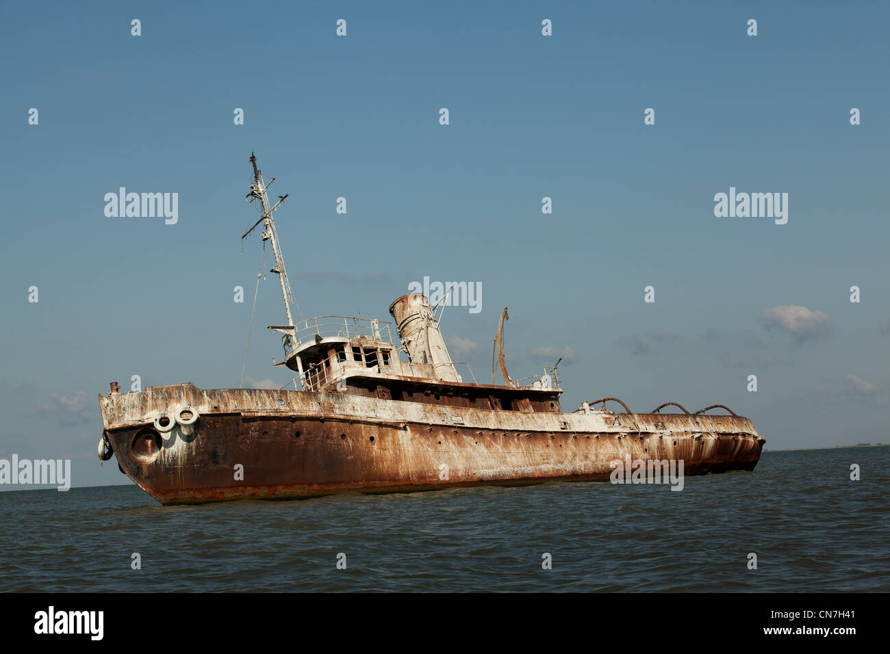side view of abandoned wrecked ship in seaside landscape Stock Photo ...