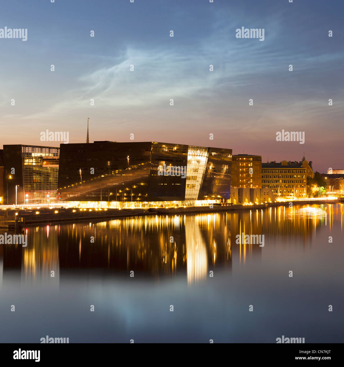 Lit buildings reflected in urban canal Stock Photo - Alamy