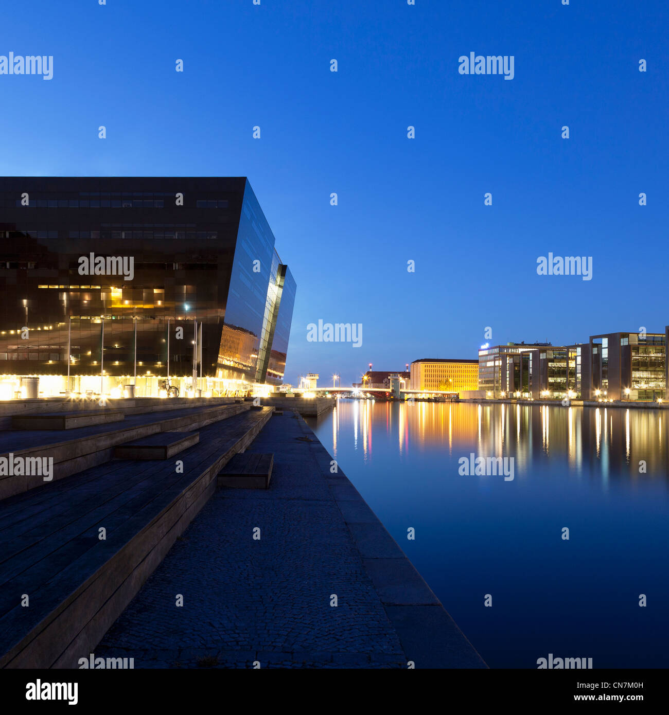 Lit buildings reflected in urban canal Stock Photo - Alamy