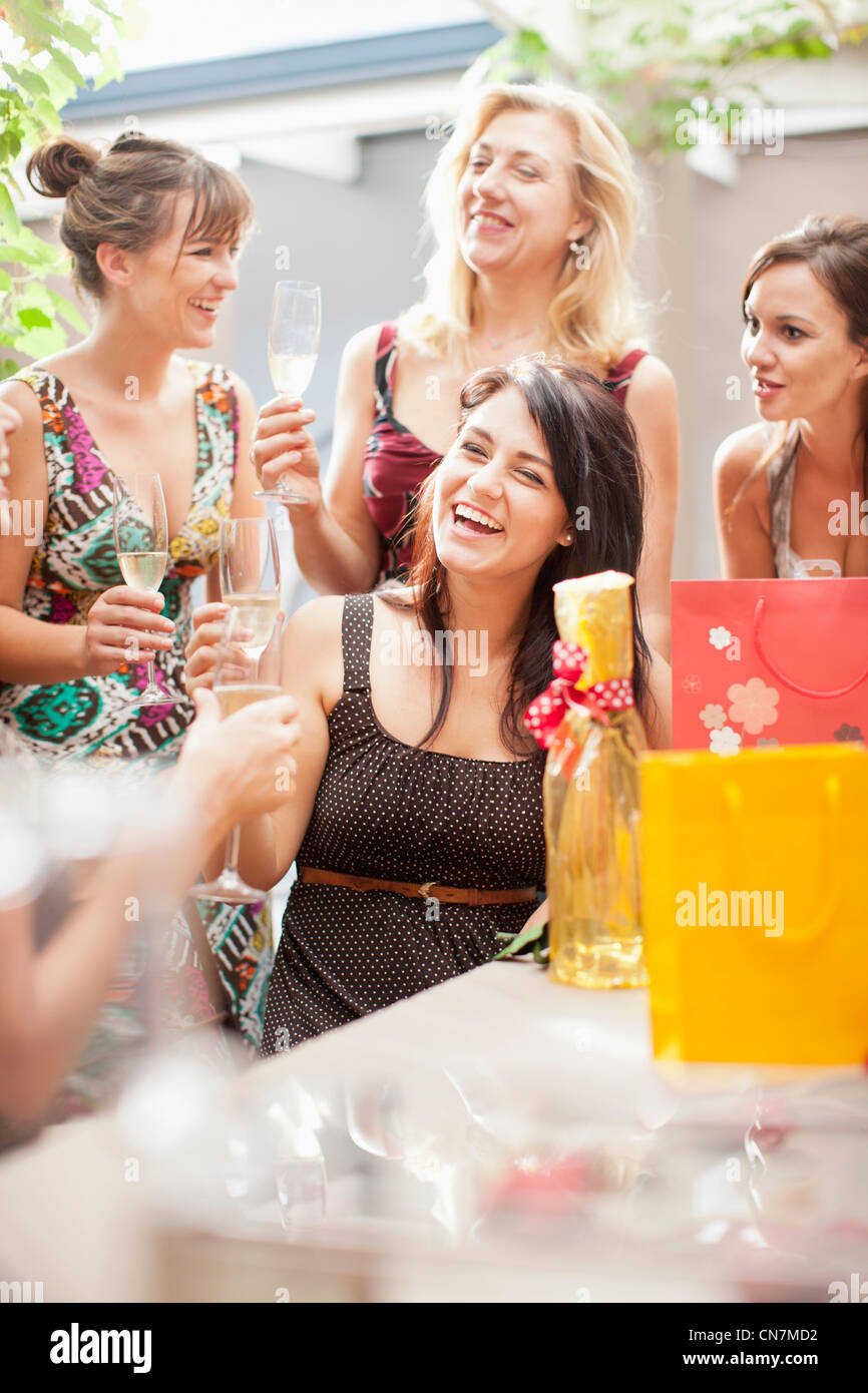 Smiling women toasting each other Stock Photo - Alamy