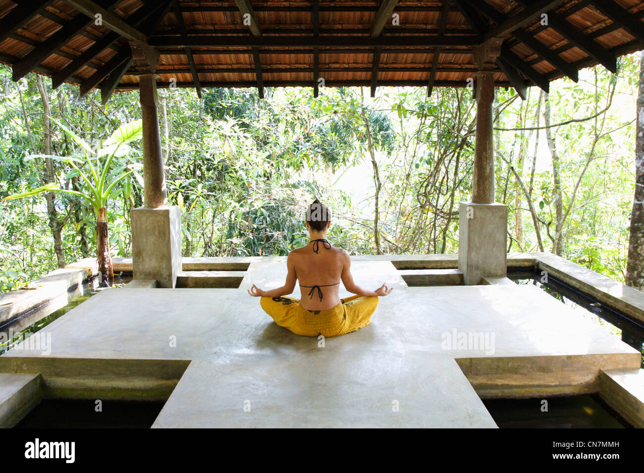 Woman practicing yoga in studio Stock Photo - Alamy