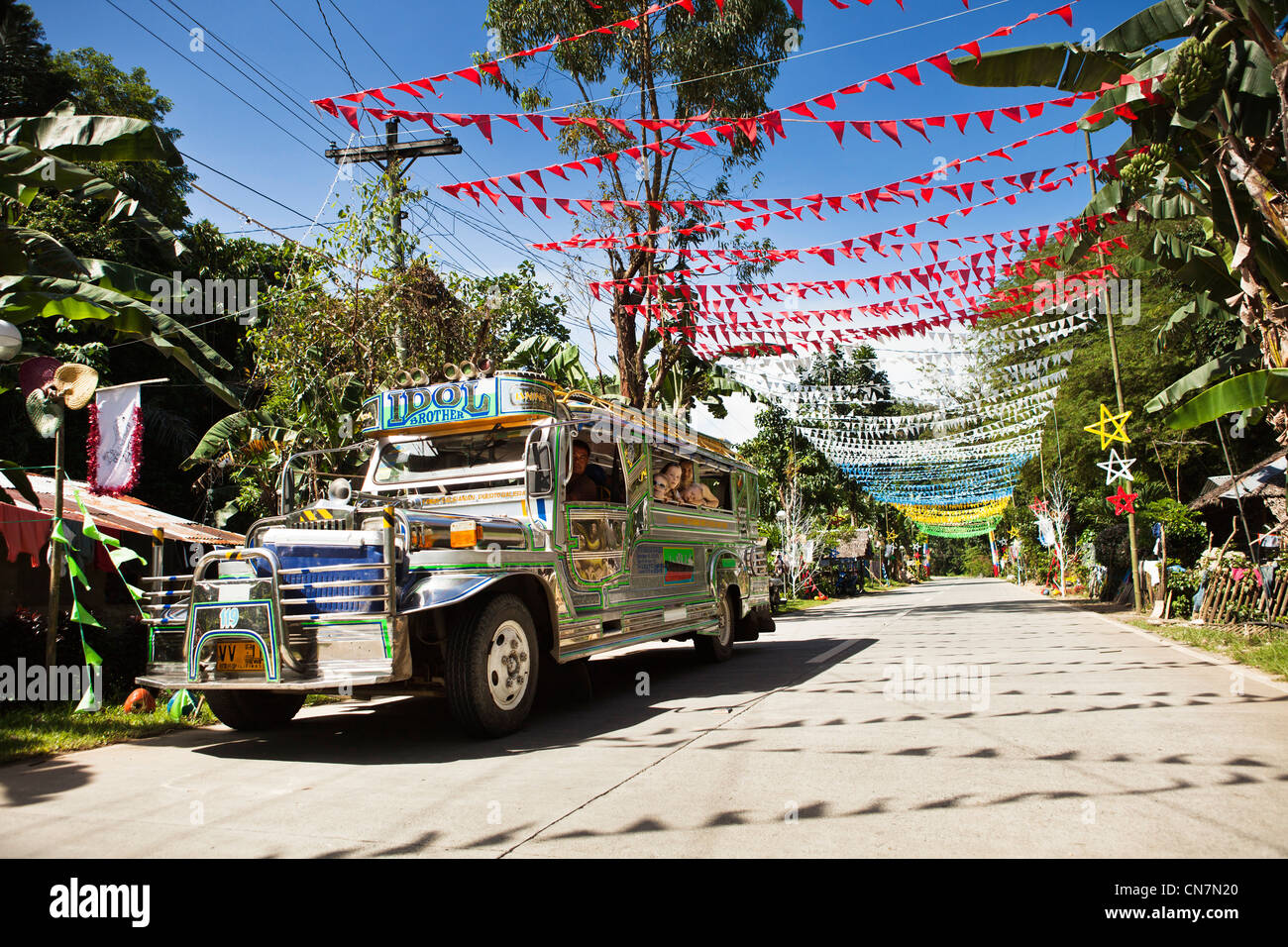 Colorful flags on tropical road Stock Photo - Alamy