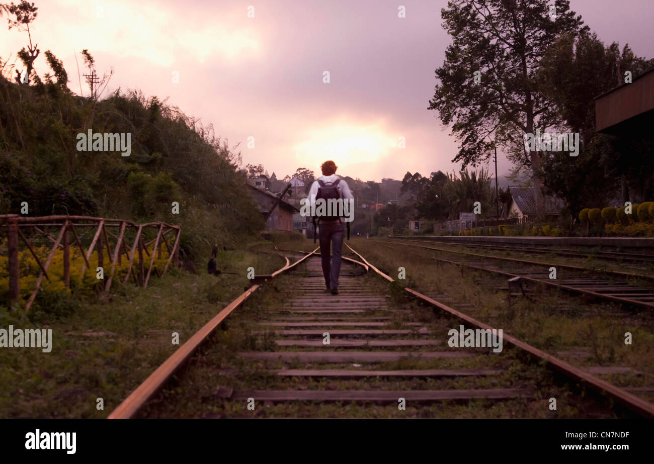Man backpacking on train tracks Stock Photo - Alamy