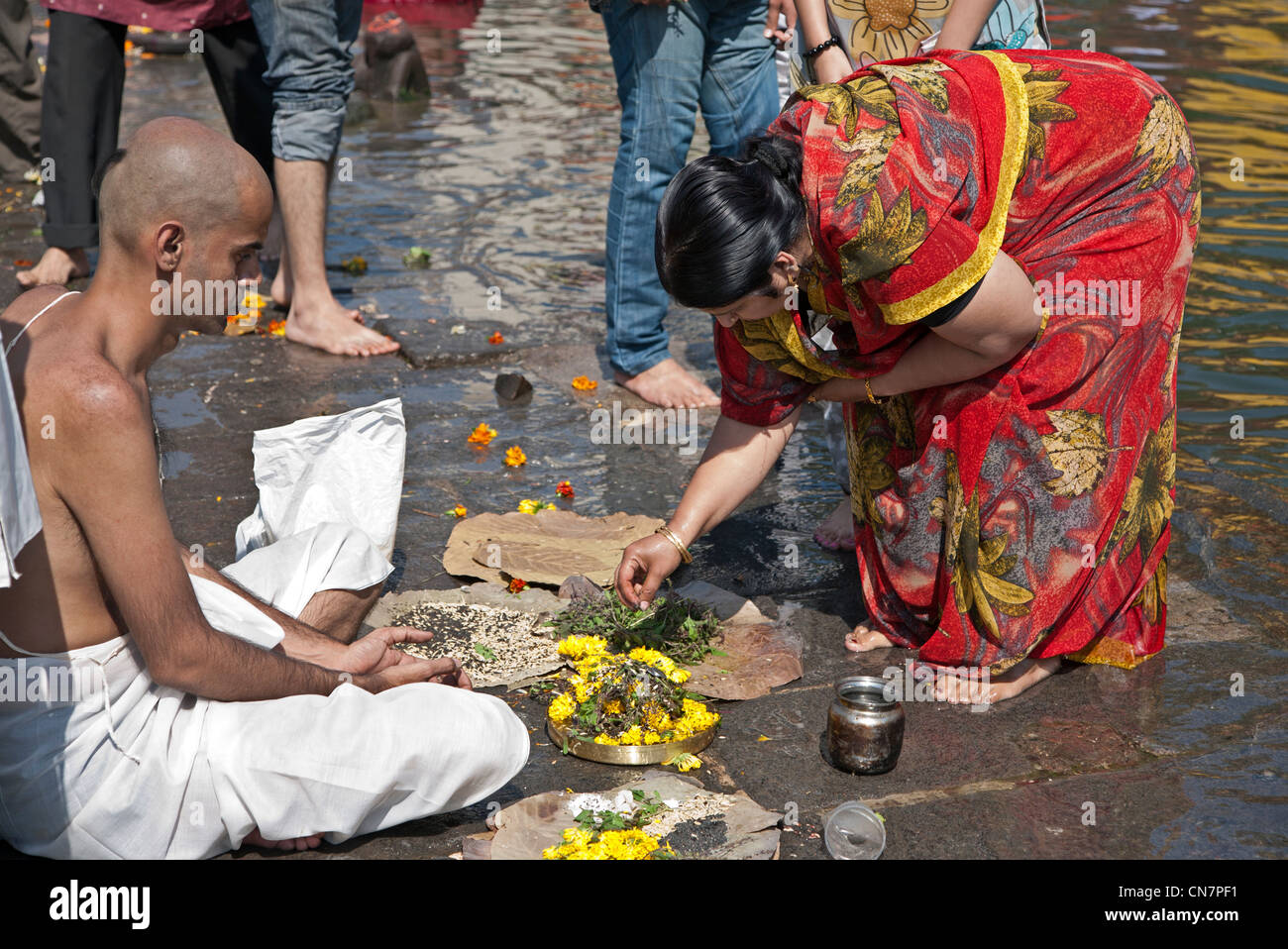 Woman making a ritual offering. Ganges river. Varanasi (Benares). India ...
