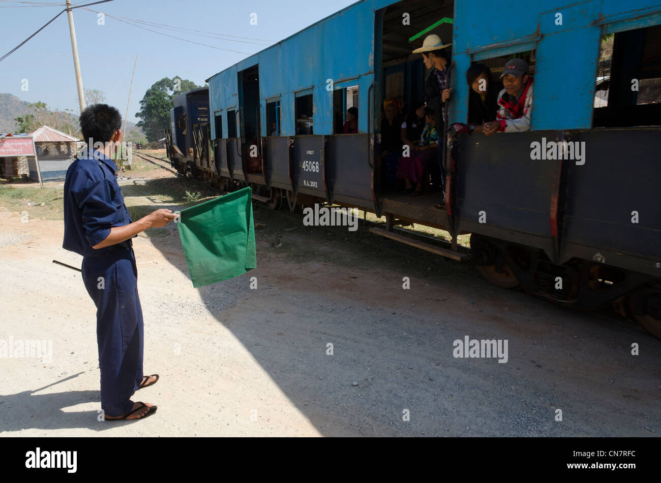 Guard at railraod crossing with train passing. Taungyi. Southern Shan ...