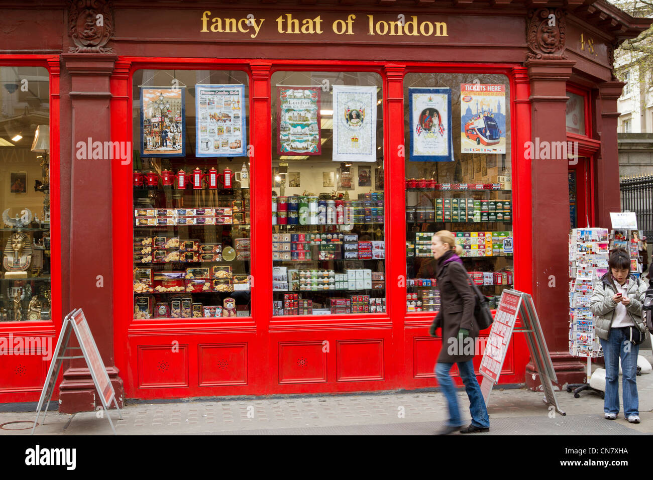 People walking past a shop selling traditional English gifts, London ...