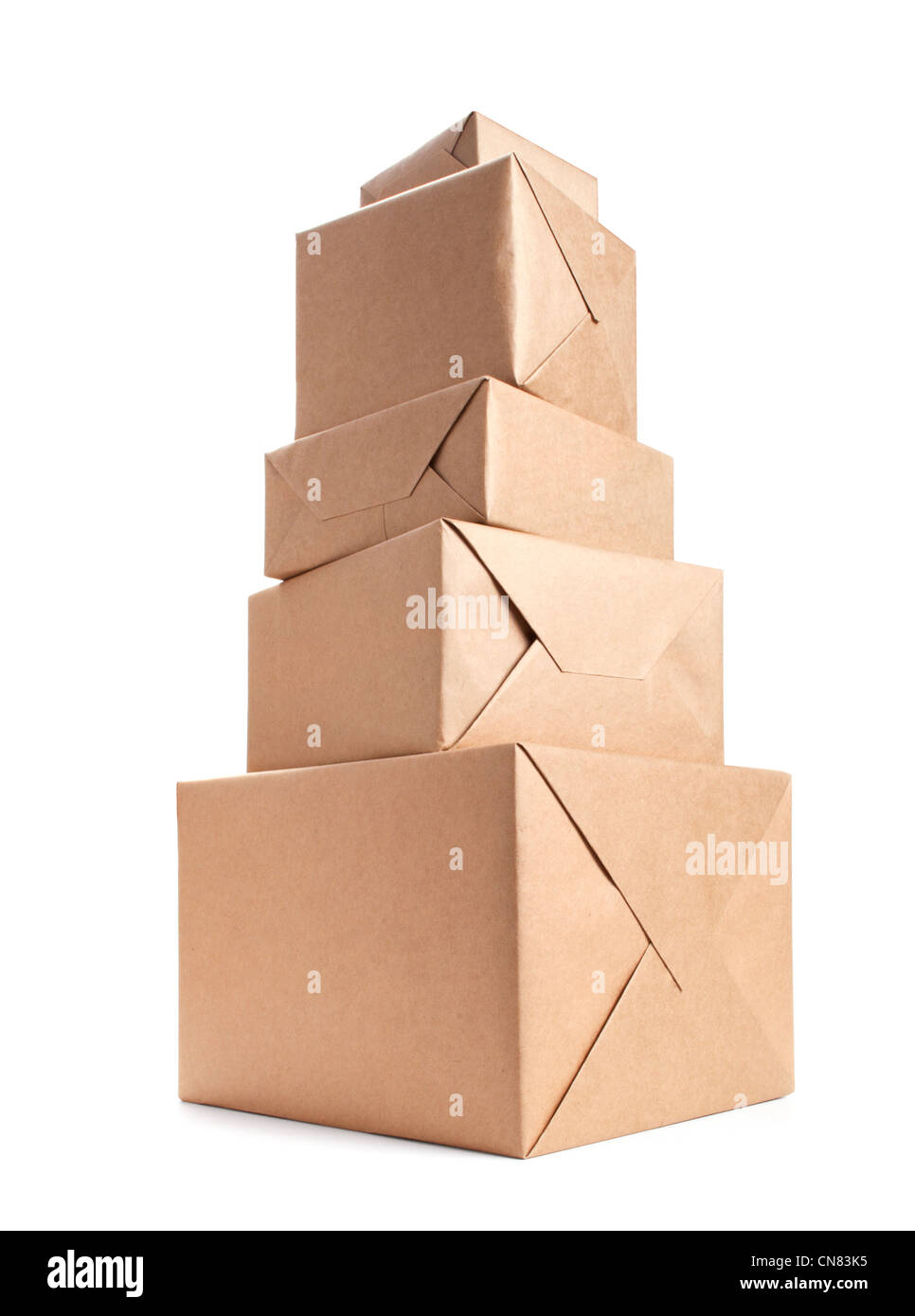 Stack of parcel wrapped with brown packing paper isolated on white ...