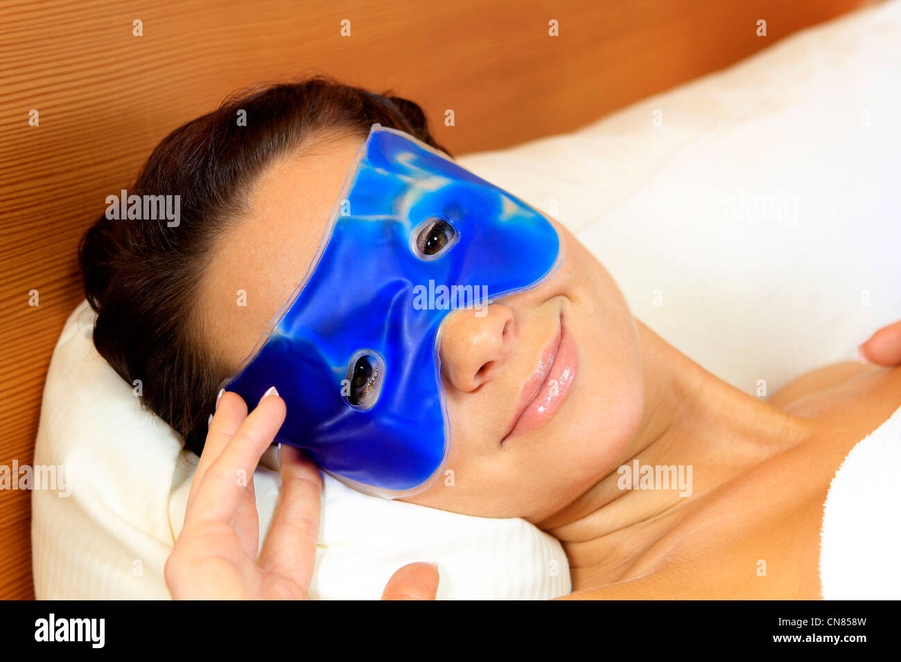 Young woman with a blue gel mask Stock Photo - Alamy