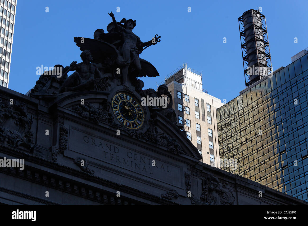 United States, New York City, Manhattan, Midtown, clock and statue of ...